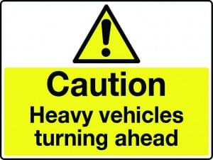 Caution Heavy vehicles turning ahead sign - Stocksigns