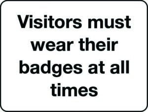 Visitors must wear their badges at all times sign - Stocksigns